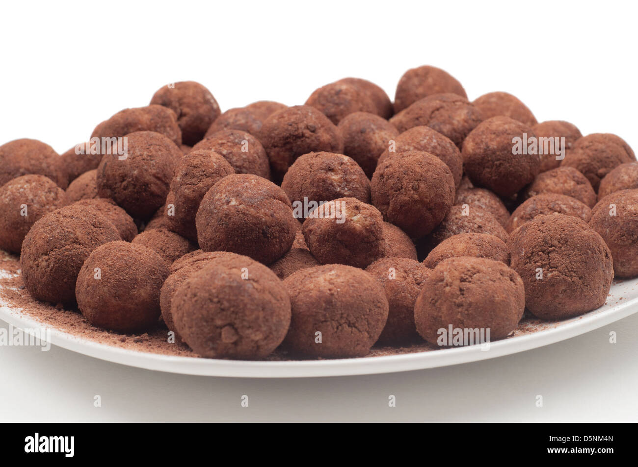 Chocolate truffles on the plate on light background Stock Photo - Alamy