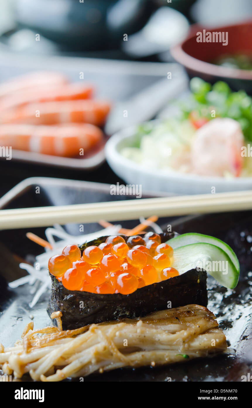 close up Salmon roe sushi with cucumber and fried enokitak mushrooms ...