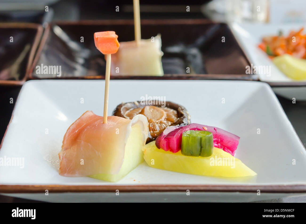 close up fish and fruit sticks with melon and mixed pickled vegetable ...