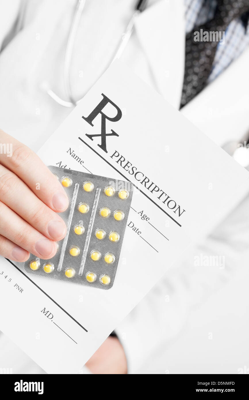 Medical doctor holding prescription in his hand Stock Photo - Alamy