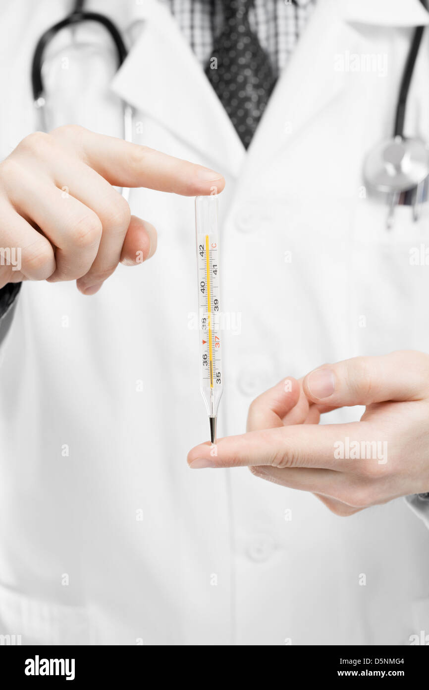 Doctor holding thermometer Stock Photo - Alamy
