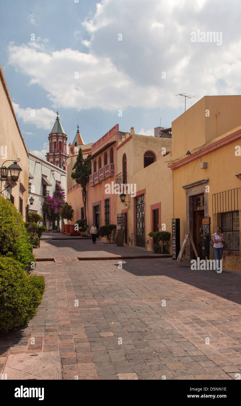 Woman walking along a quiet street in the historic districts of ...