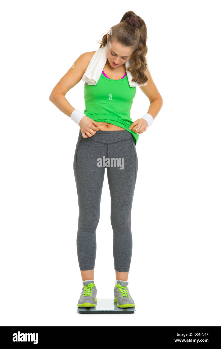 Fitness young woman checking body fat while standing on scales Stock ...