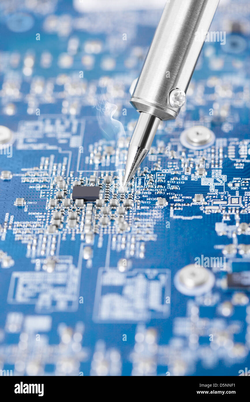 Microcircuit being fixed with soldering iron - sharp photo Stock Photo ...