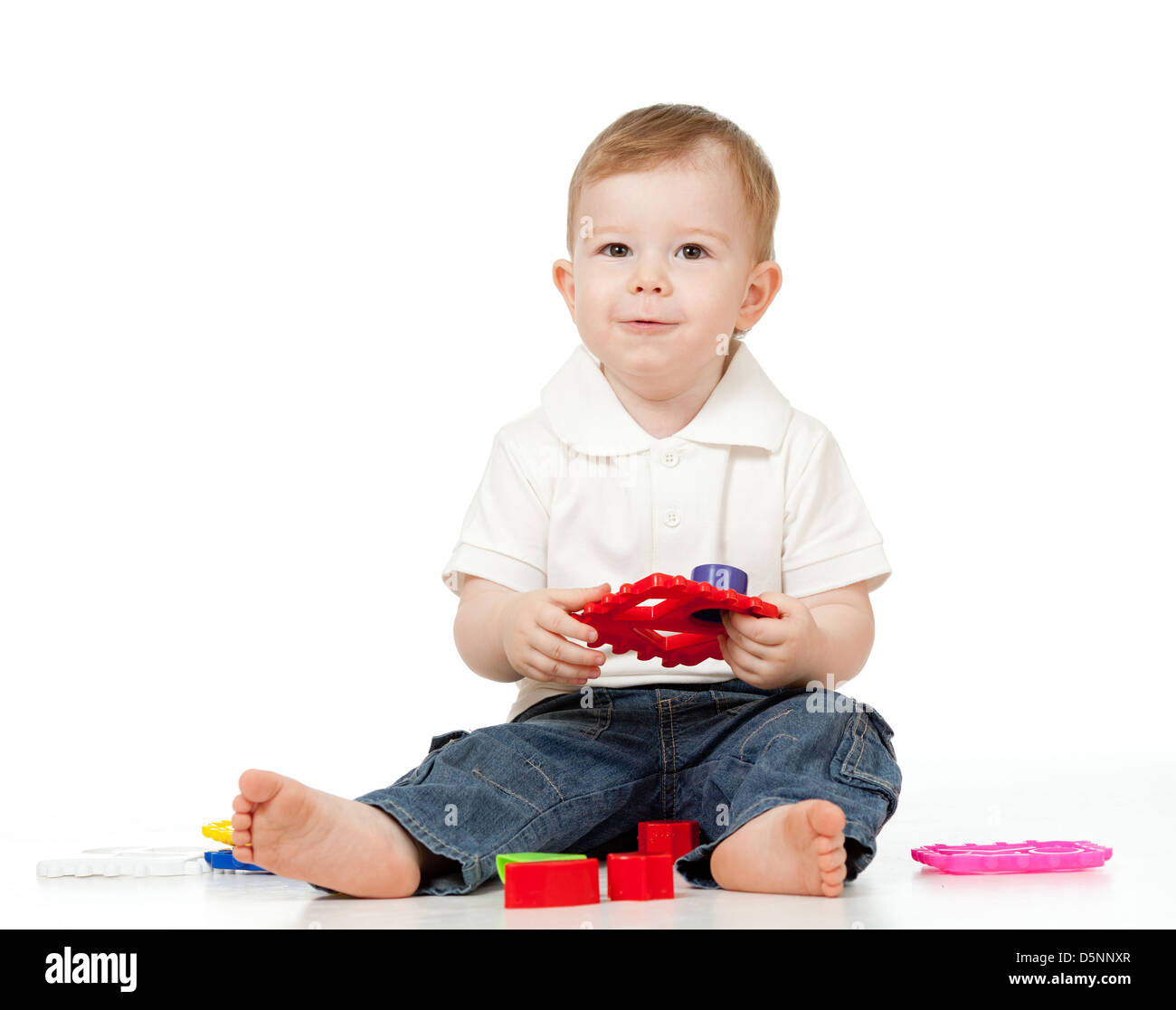Cute little child is playing with toys while sitting on floor, isolated ...