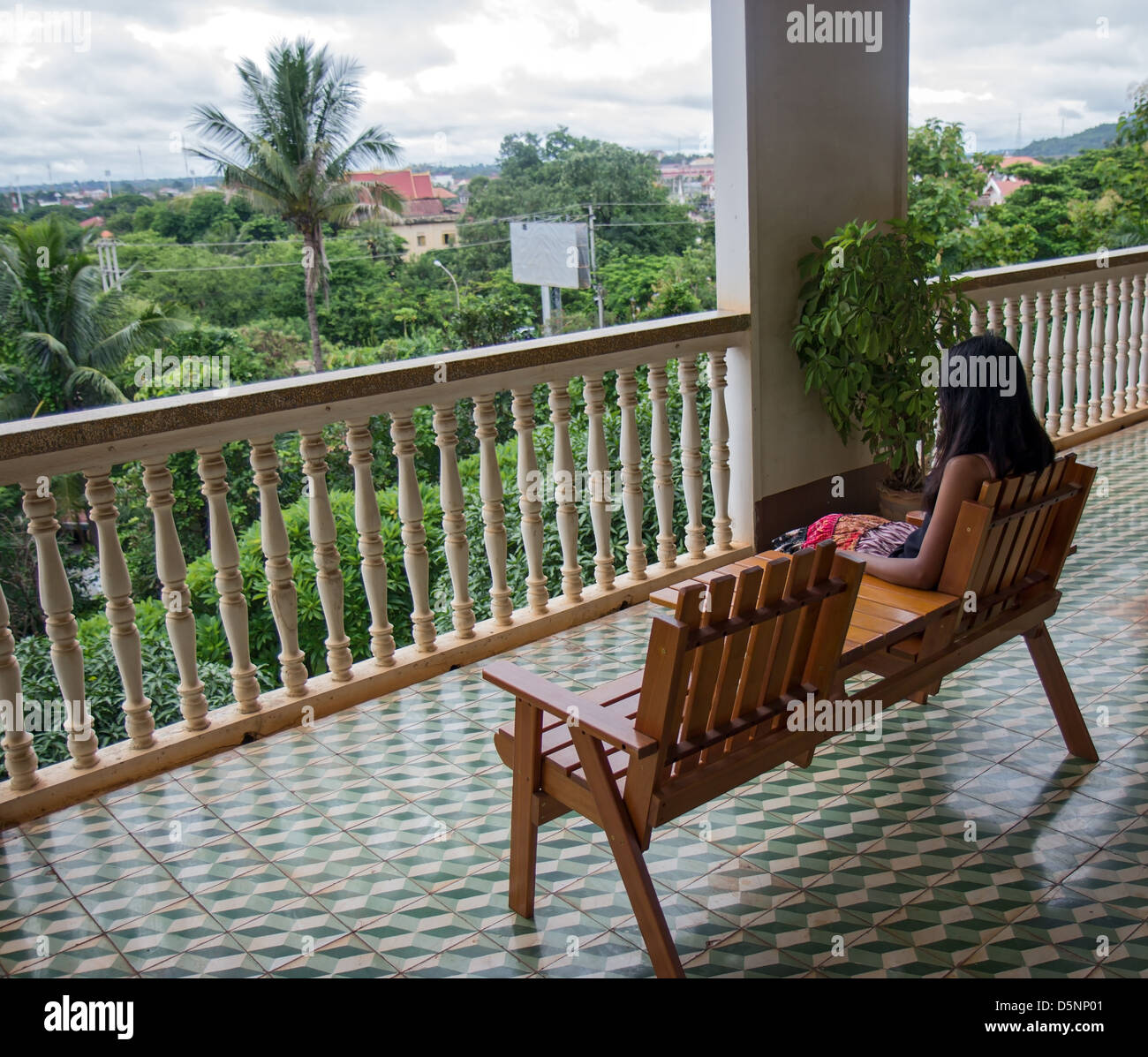woman sitting on a bench in the hallway Stock Photo - Alamy