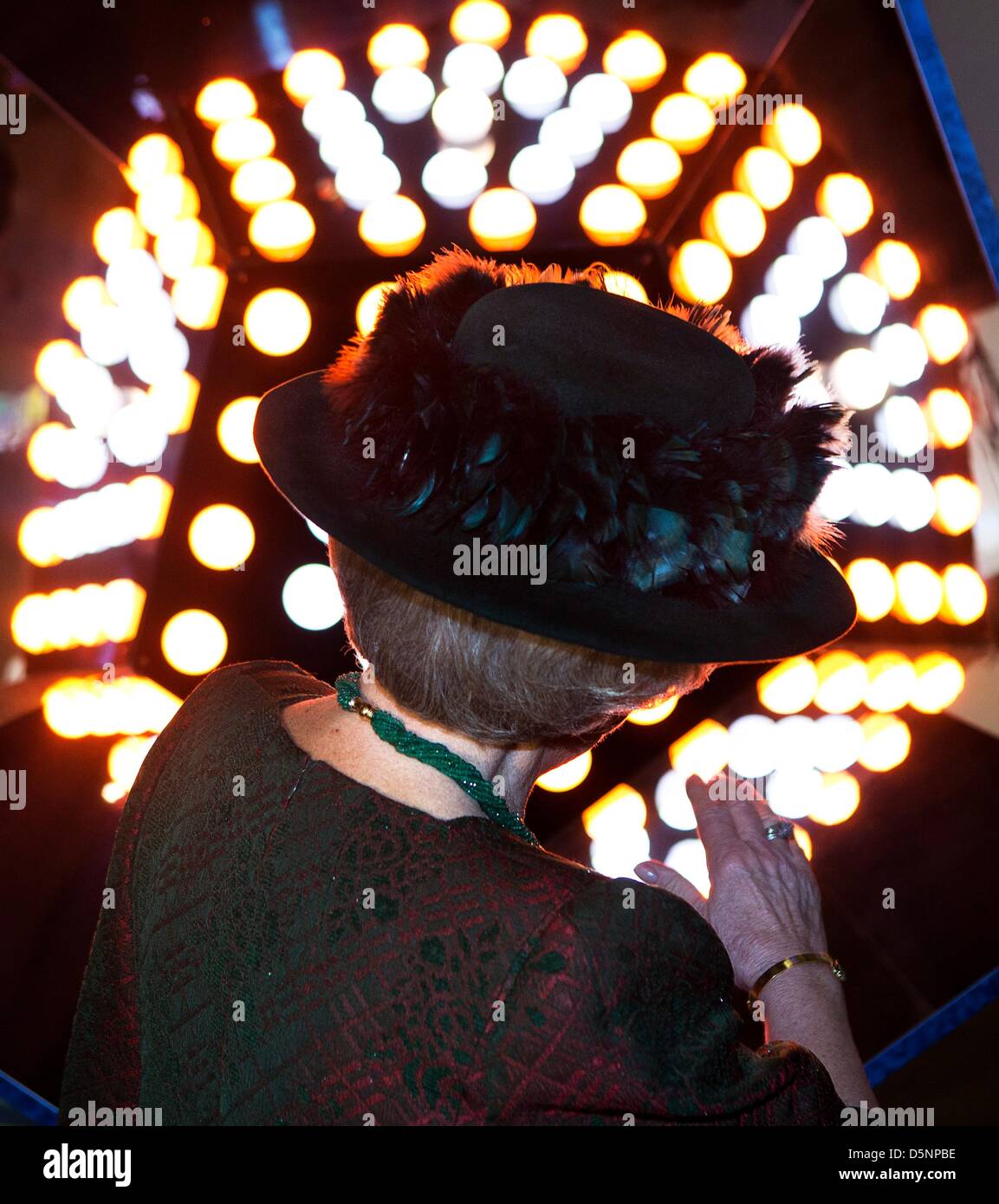 Queen Beatrix of The Netherlands opens the Philips museum by turning a lightbulb into a light ...