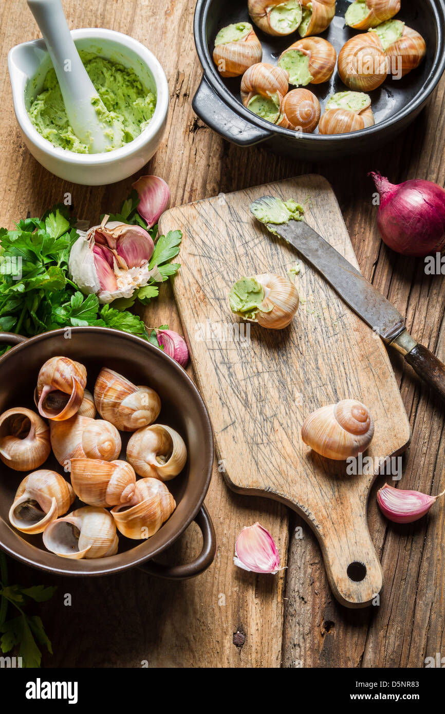Preparing baked snails with garlic butter Stock Photo - Alamy