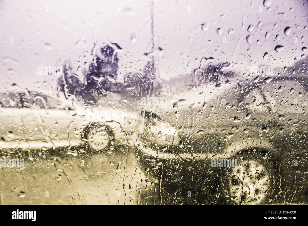 Raindrops on the car window while driving in rain Stock Photo - Alamy