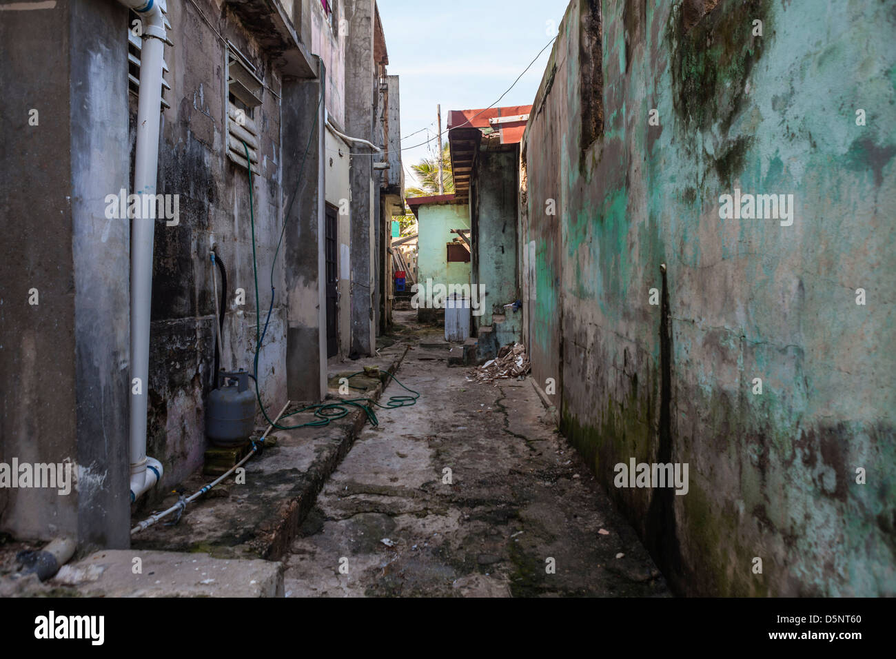 Grungy narrow dangerous looking barrio back alley Stock Photo - Alamy