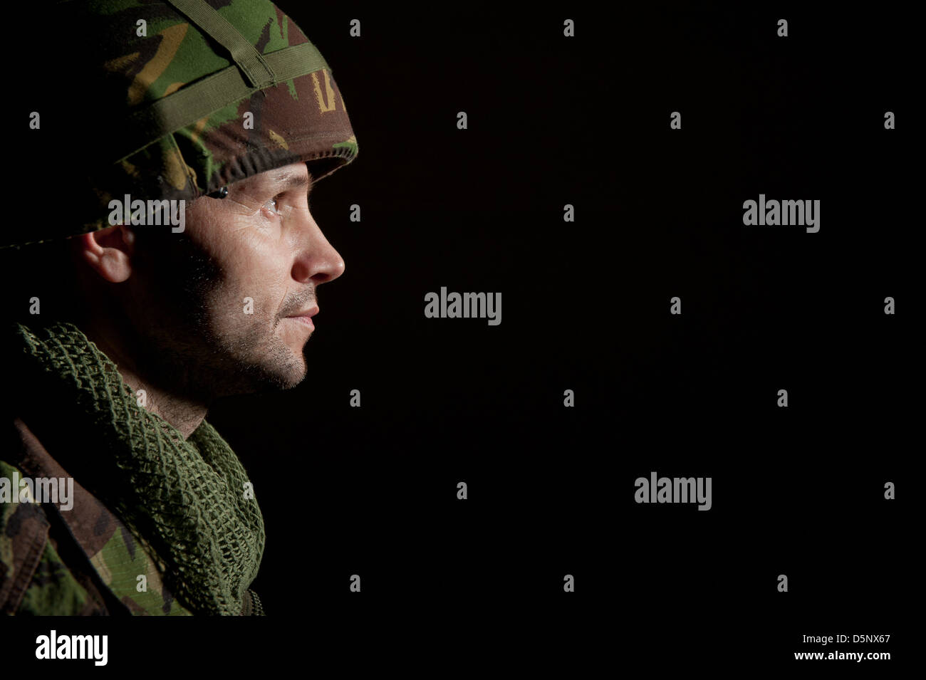 Portrait in profile of a British soldier against a black background ...