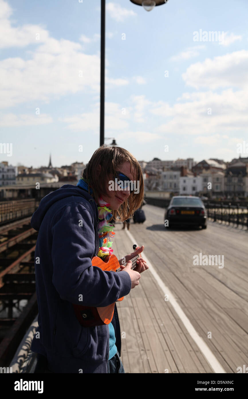 Ryde, Isle of Wight, UK. 6th April 2013 A busker greeting passengers to ...