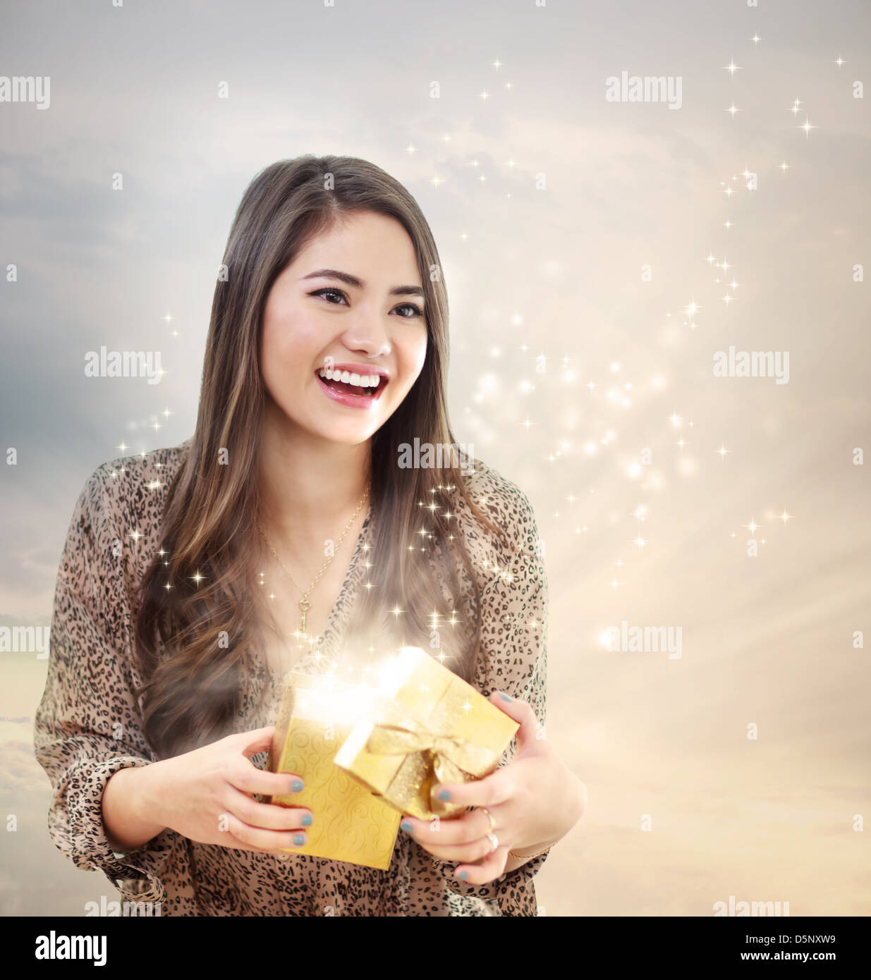 Girl Opening a Magical Golden Gift Box Stock Photo - Alamy