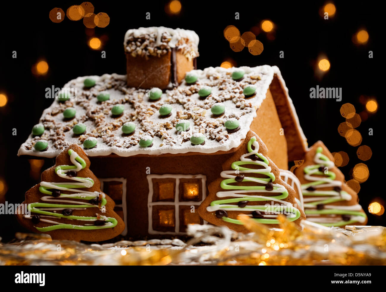 Gingerbread house with lights inside, dark background Stock Photo - Alamy