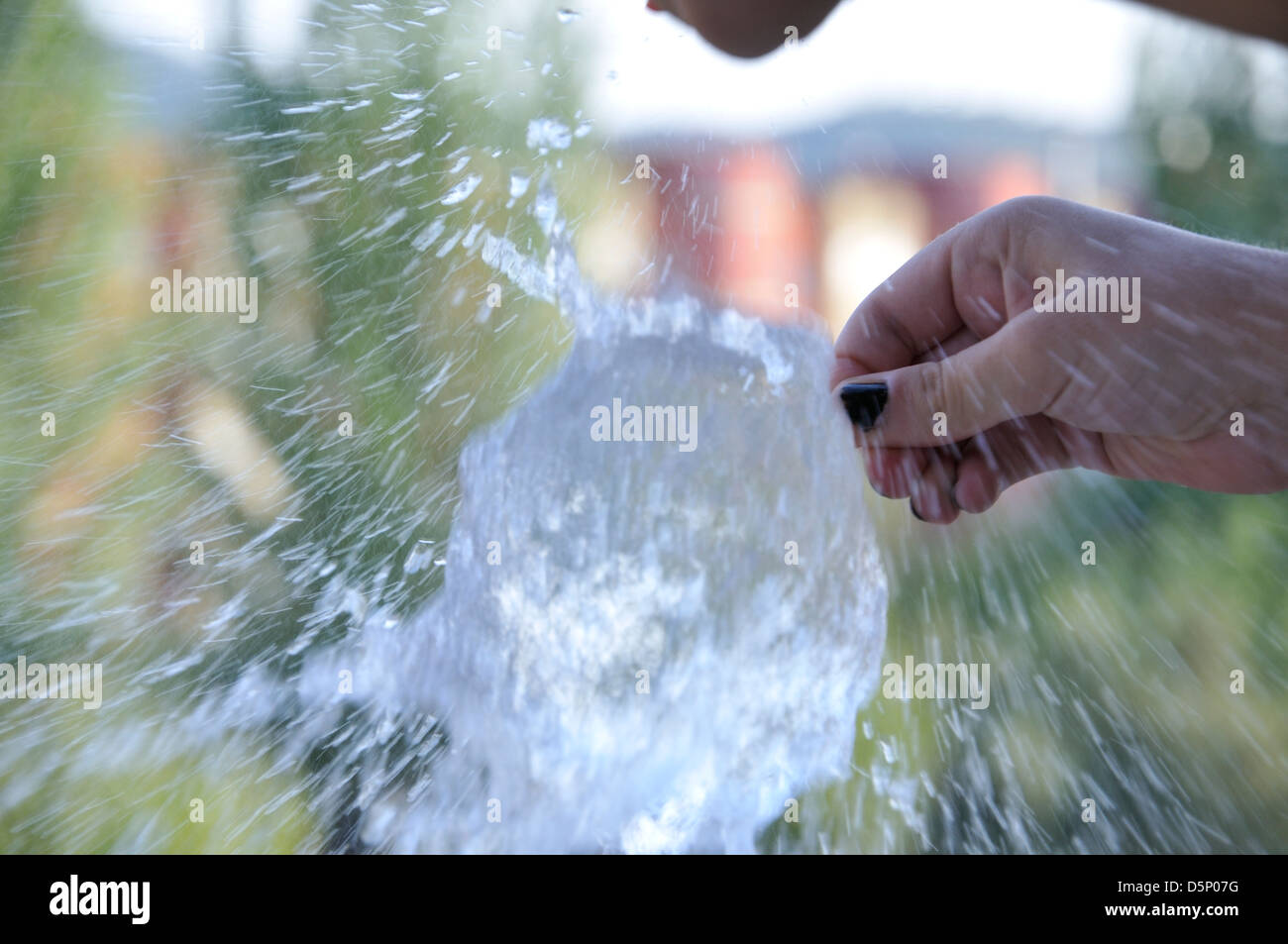 water balloon explosion with a needle to capture the right moment Stock ...