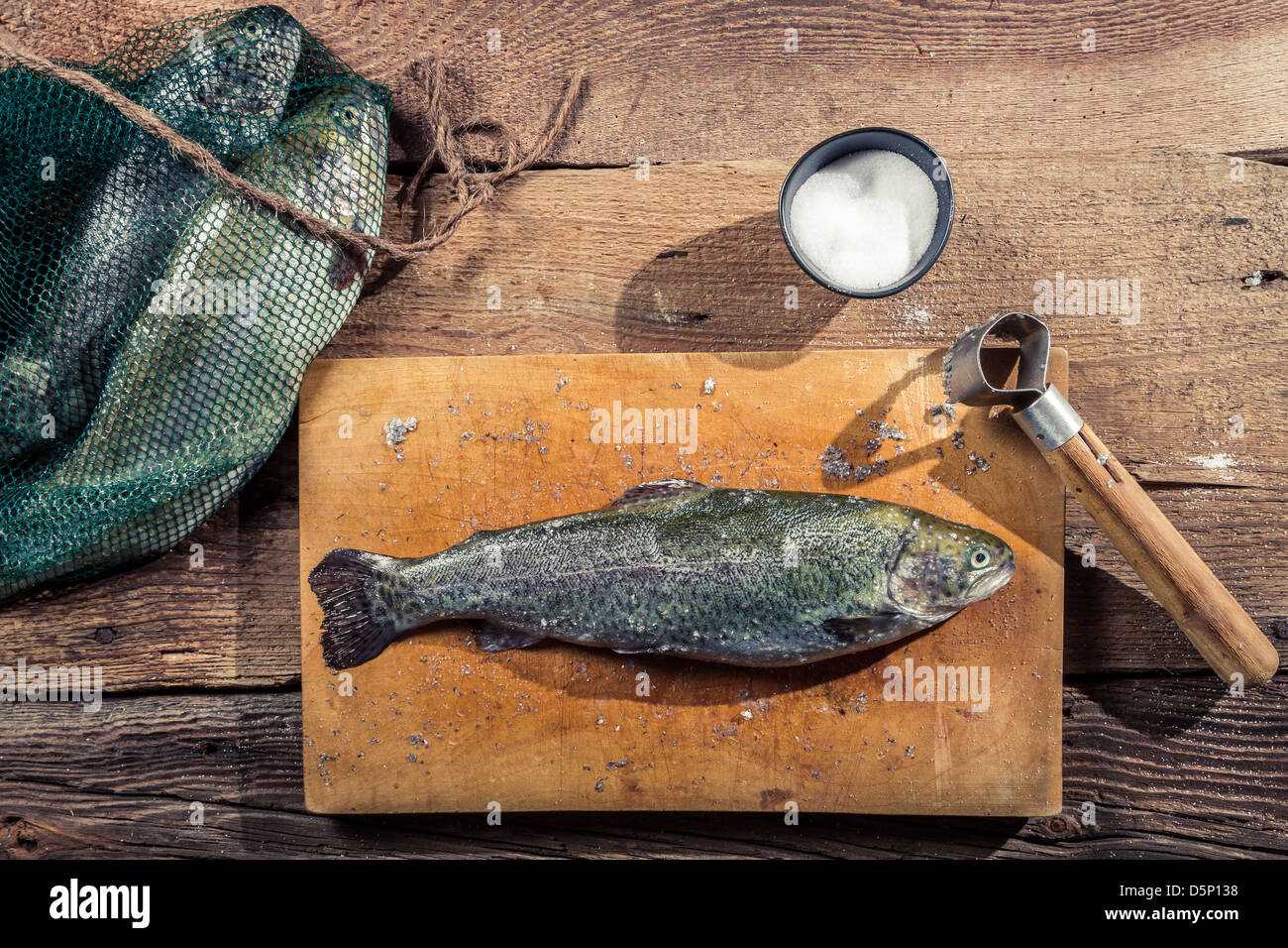 Preparing freshly caught fish from the lake Stock Photo - Alamy