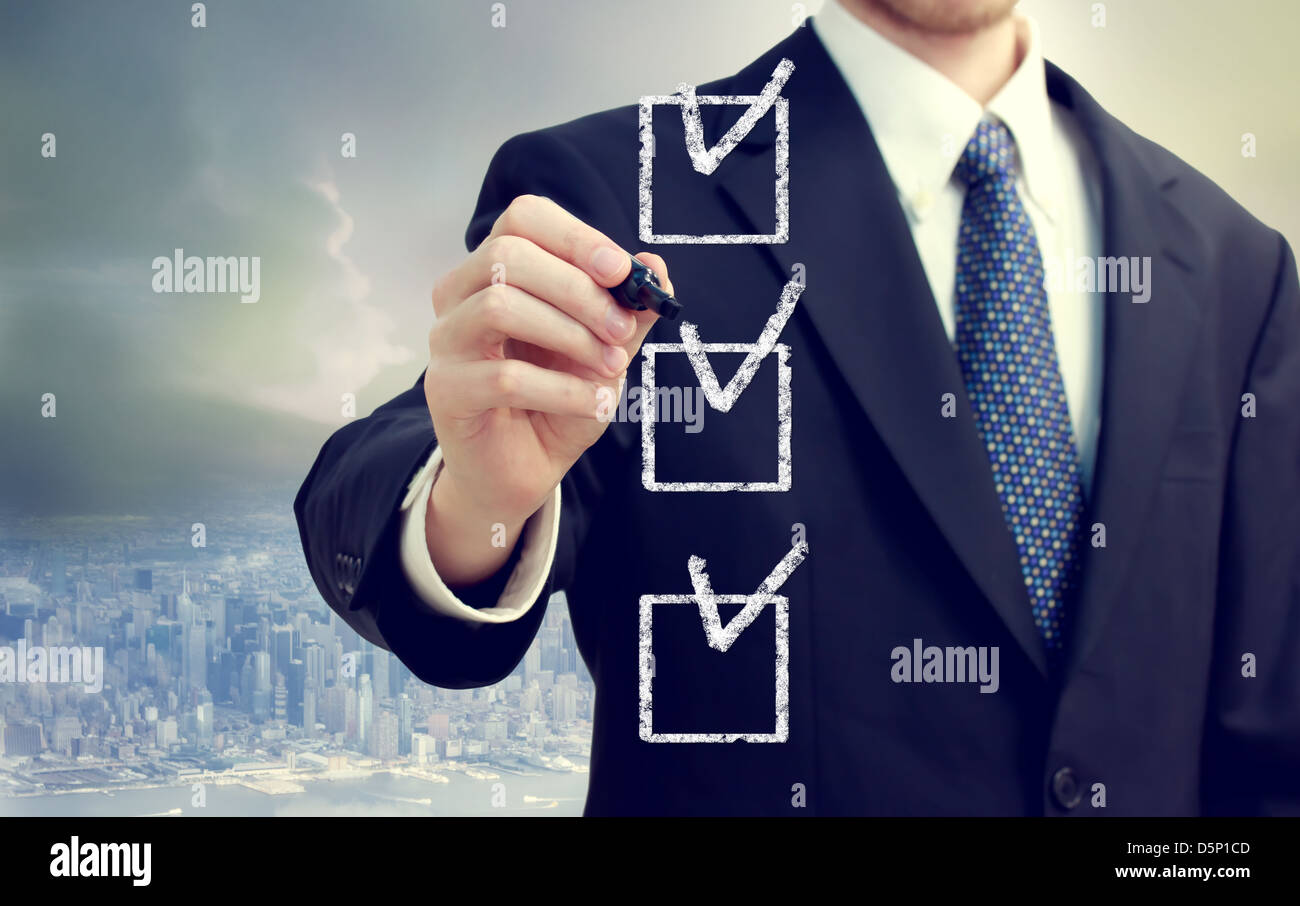 Business man checking off checkboxes with cityscape background Stock ...