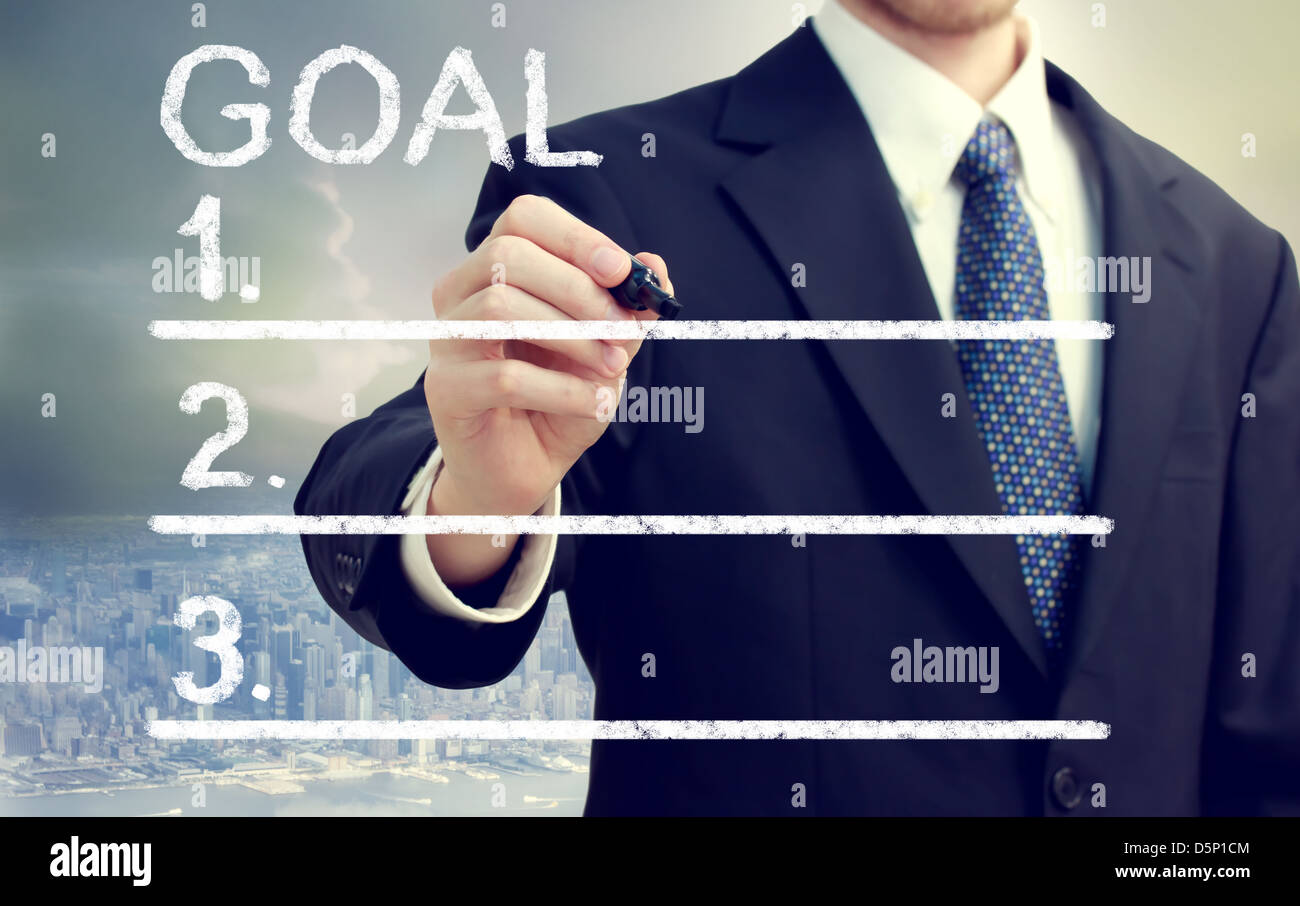 Businessman listing his goals with cityscape background Stock Photo - Alamy