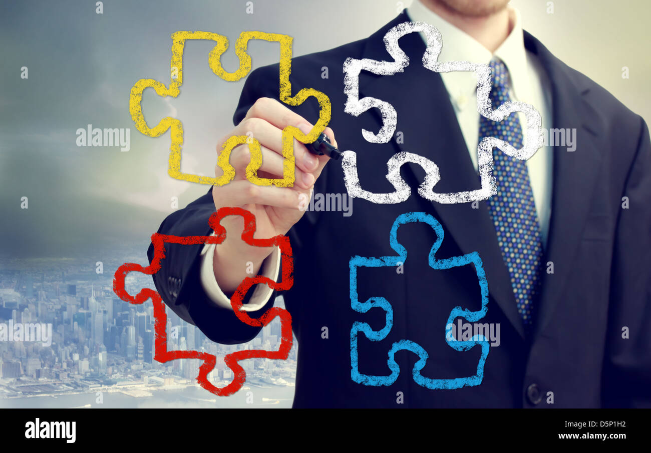 Businessman with puzzle pieces - concepts of strategy, creativity, and ...