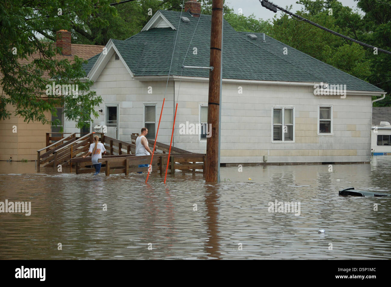 A canoe moves through floodwaters in the Midwest during severe flooding ...