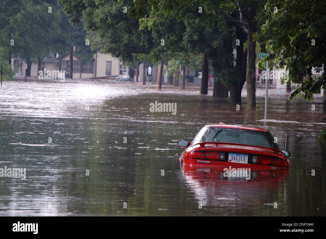 This image shows a canoe on flood-affected waters in Iowa, part of the ...