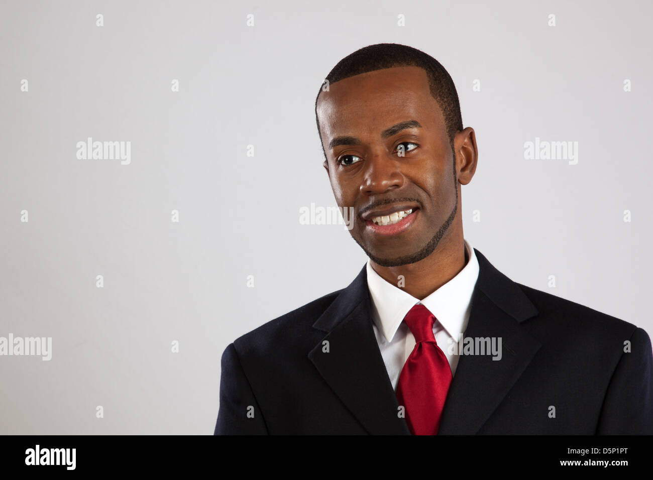 Happy black man in a blue plaid shirt, looking at the camera with a ...