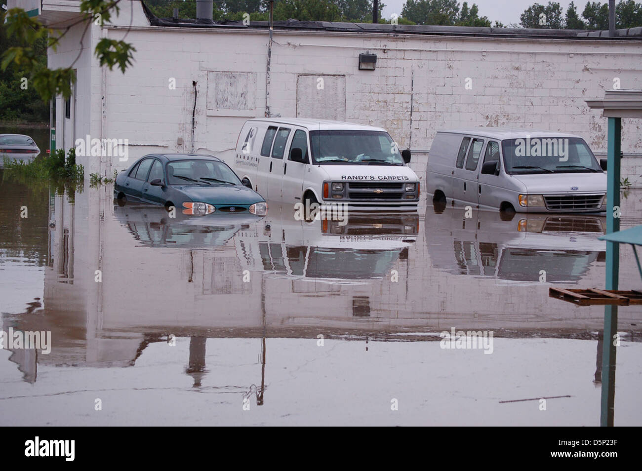 This photograph shows a canoe navigating through flooded waters in Iowa ...