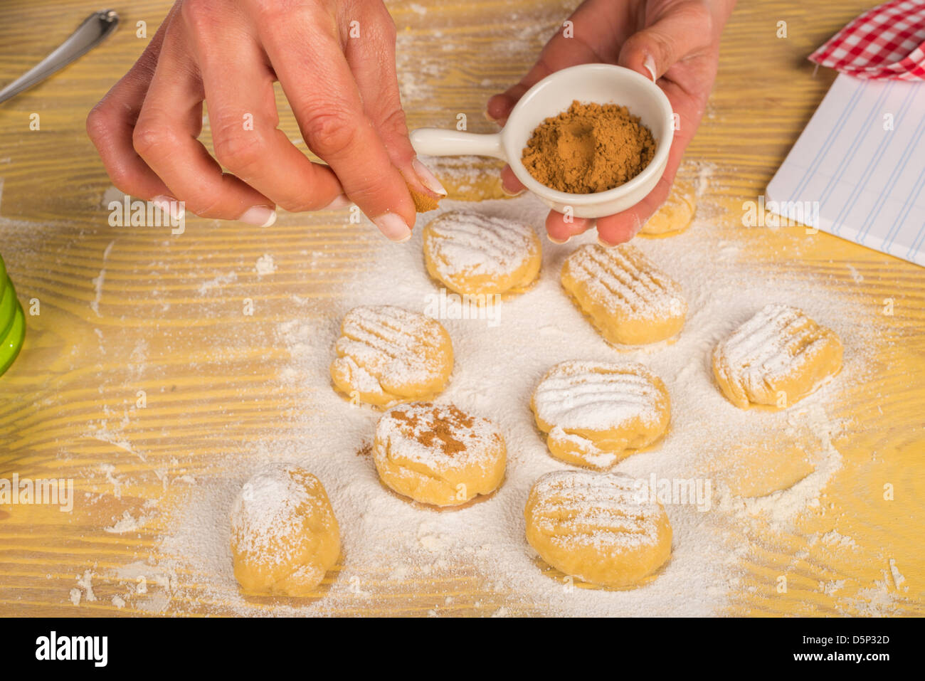 Sprinkling cinnamon on top of homemade cookies Stock Photo - Alamy
