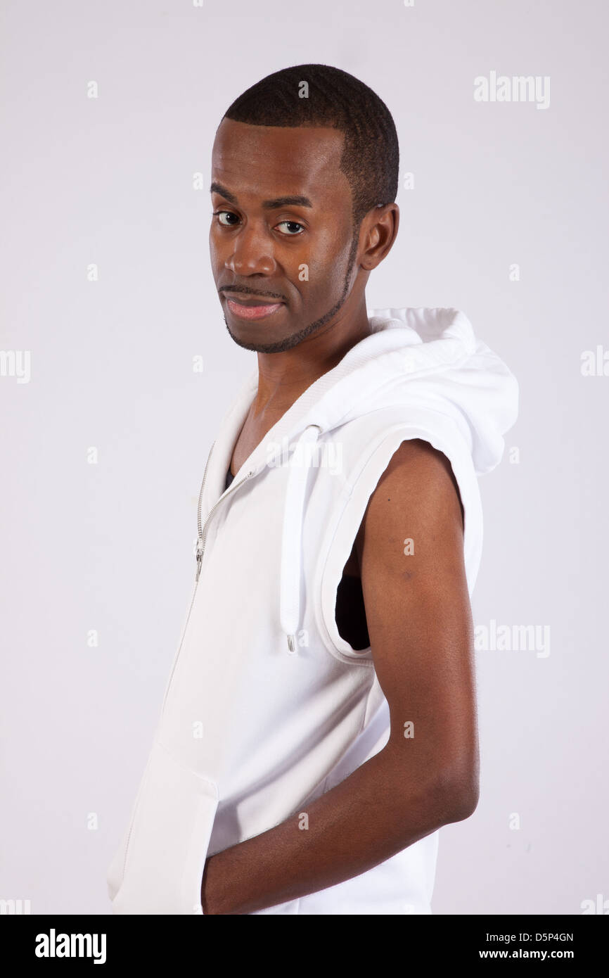 Handsome black man wearing a white hooded, sleeveless shirt, looking at ...