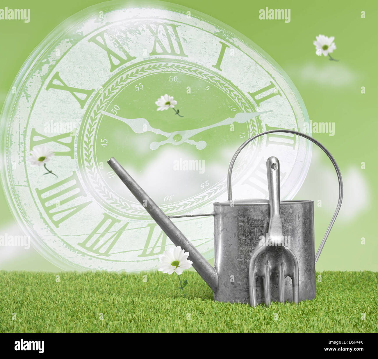 Spring planting time with watering can and garden fork on grass Stock ...