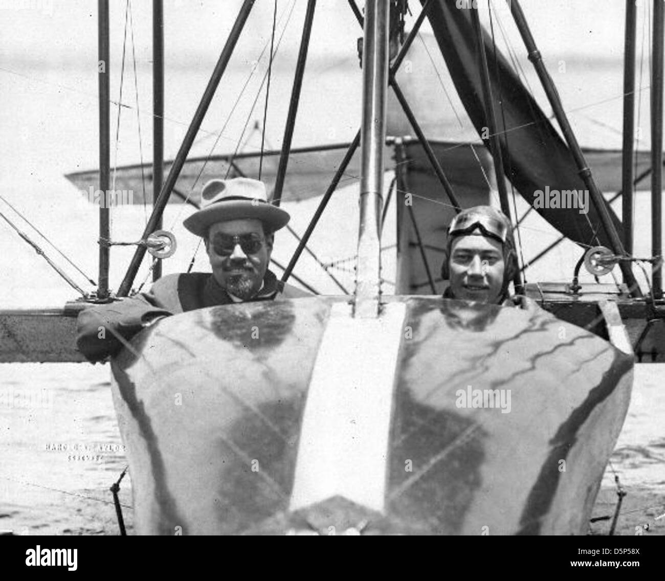 This image shows Ray Morris, an aviator, alongside his Curtiss aircraft ...