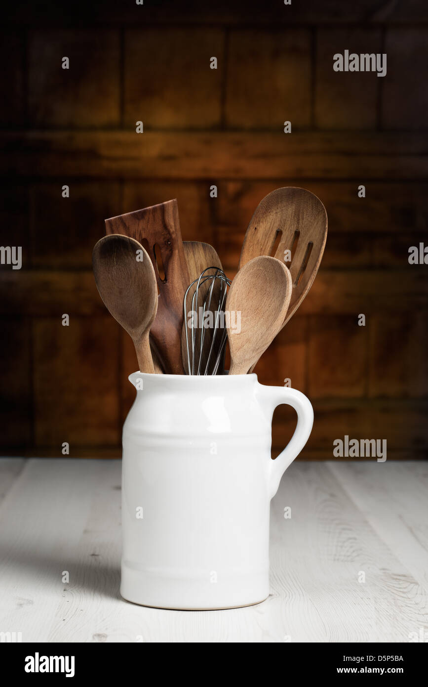 Jug of rustic wooden spoons in farmhouse kitchen Stock Photo - Alamy