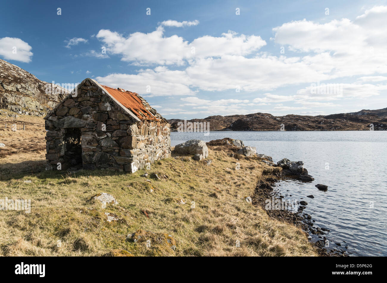 A small bothy next to a loch on great Bernera in the Outer Hebrides of ...