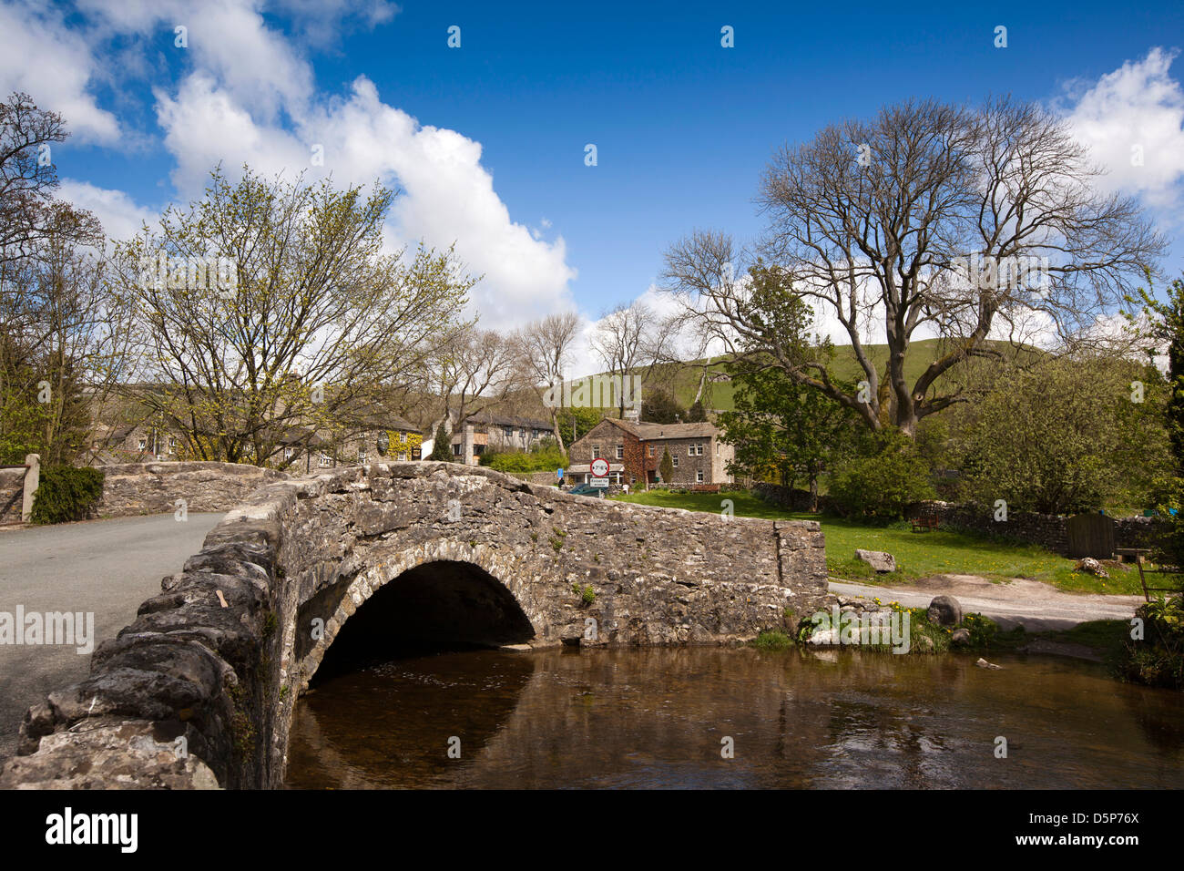 UK, England, Yorkshire, Malham, old stone bridge across River Aire ...