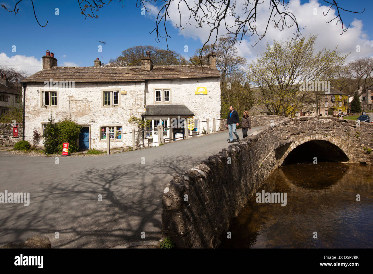 UK, England, Yorkshire, Malham, village shop beside old stone bridge ...