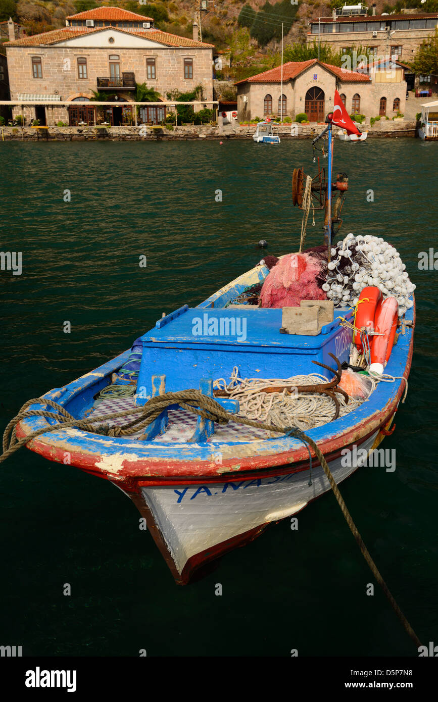 Fishing boat with hotels and police station in the hamlet of Assos ...