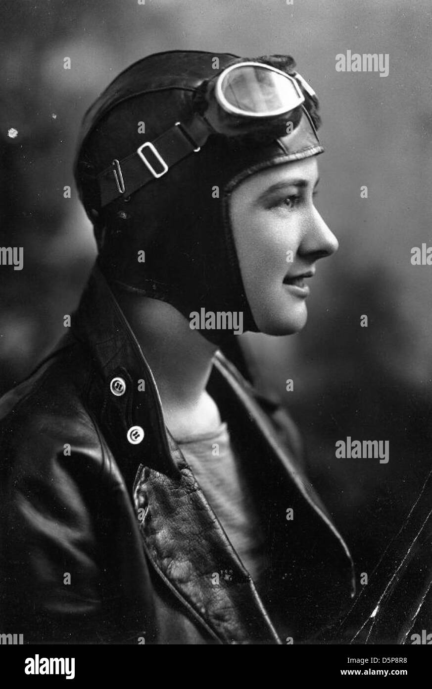 The photograph of a young woman pilot wearing goggles and a leather ...
