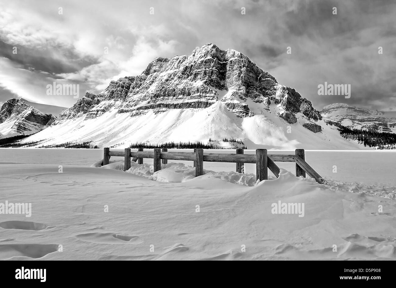 This is Bow Mountain in the background with wood bridge covered of snow ...