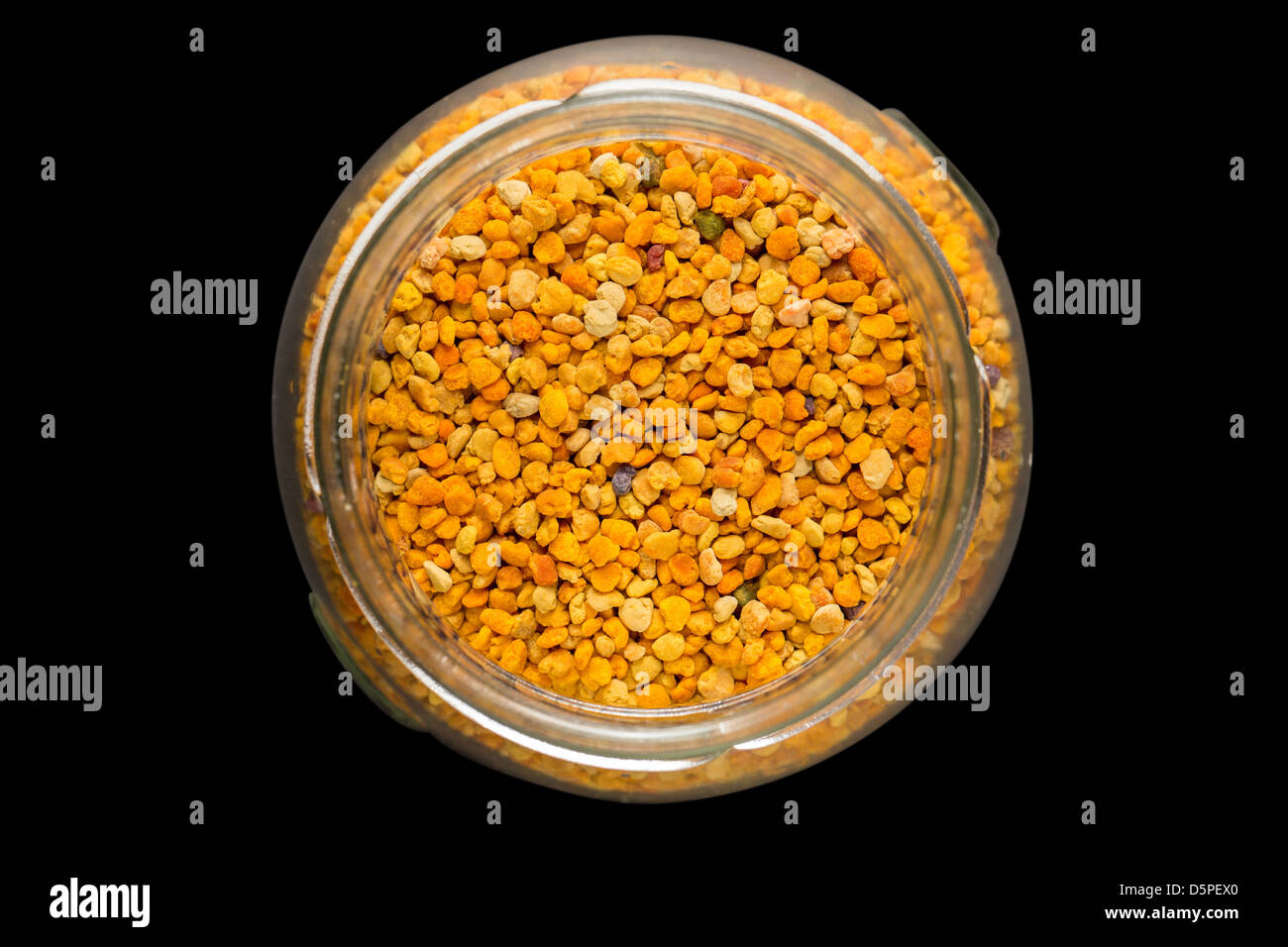 Top view of jar with pollen over black background Stock Photo - Alamy