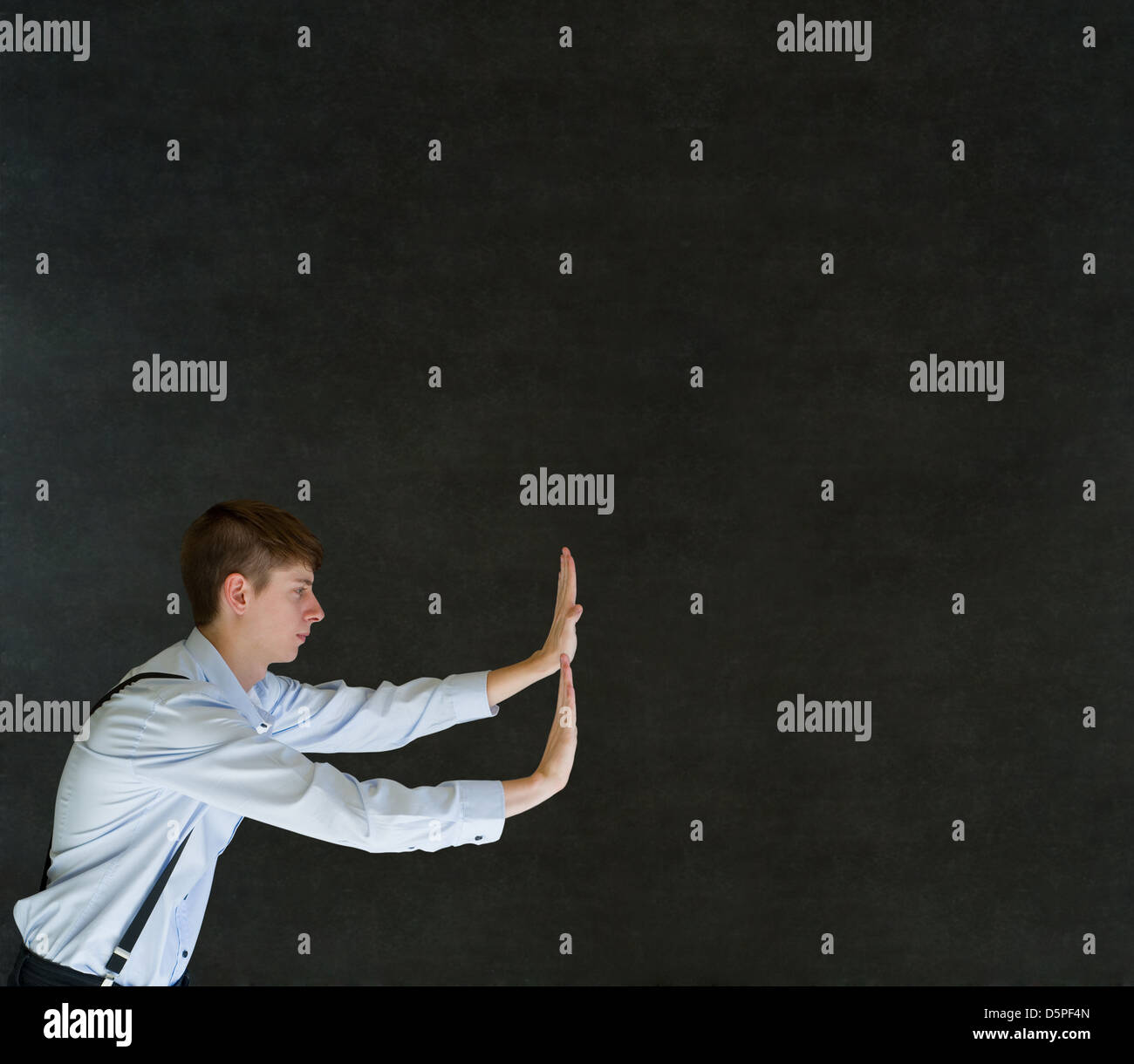 Business man, student or teacher pushing on blackboard background add ...