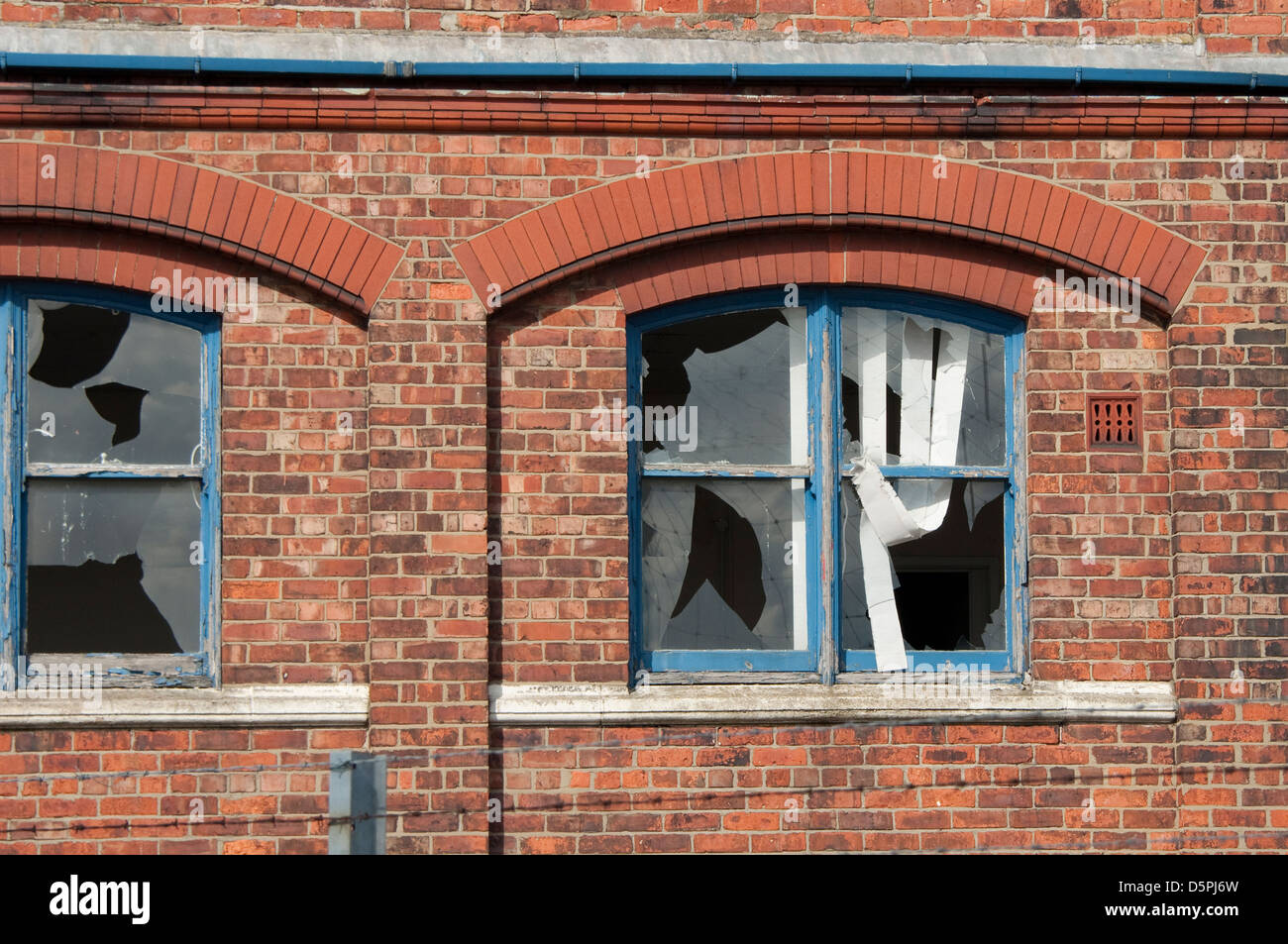 Broken windows on derelict building Stock Photo - Alamy
