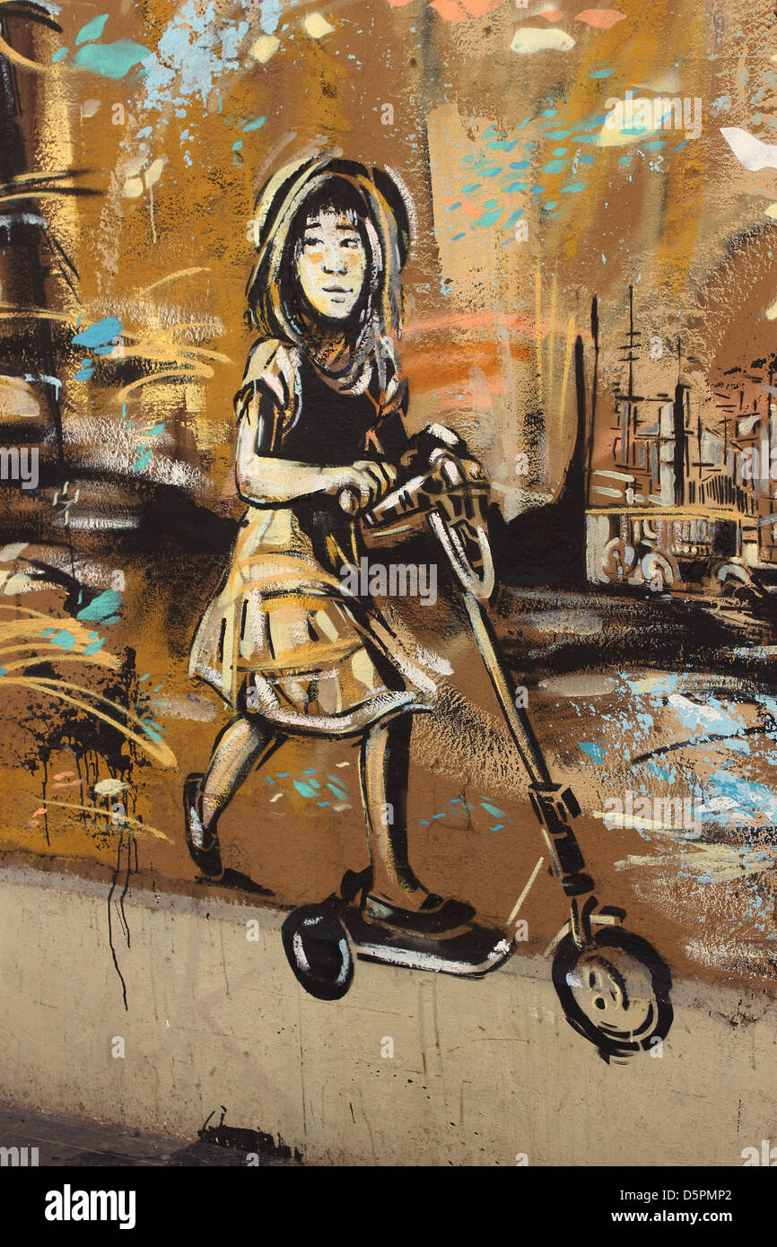 Child with scooter in painted wall - graffiti Stock Photo - Alamy