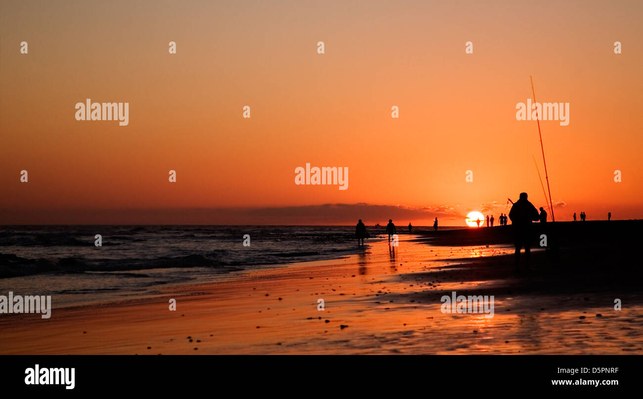 People on the beach at beautiful sunset Stock Photo - Alamy