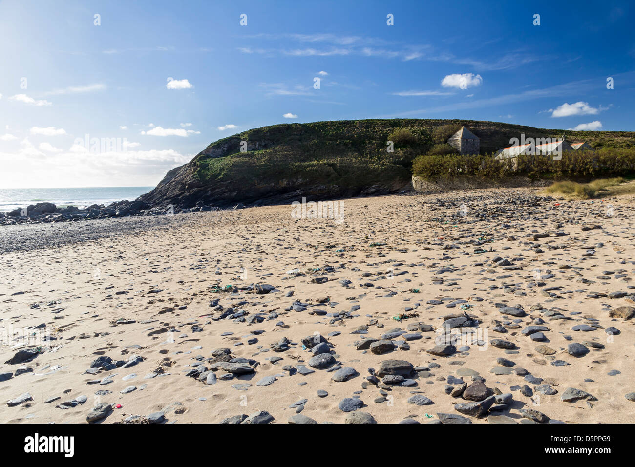 The beach and Church of St Winwaloe at Gunwalloe Church Cove Cornwall ...