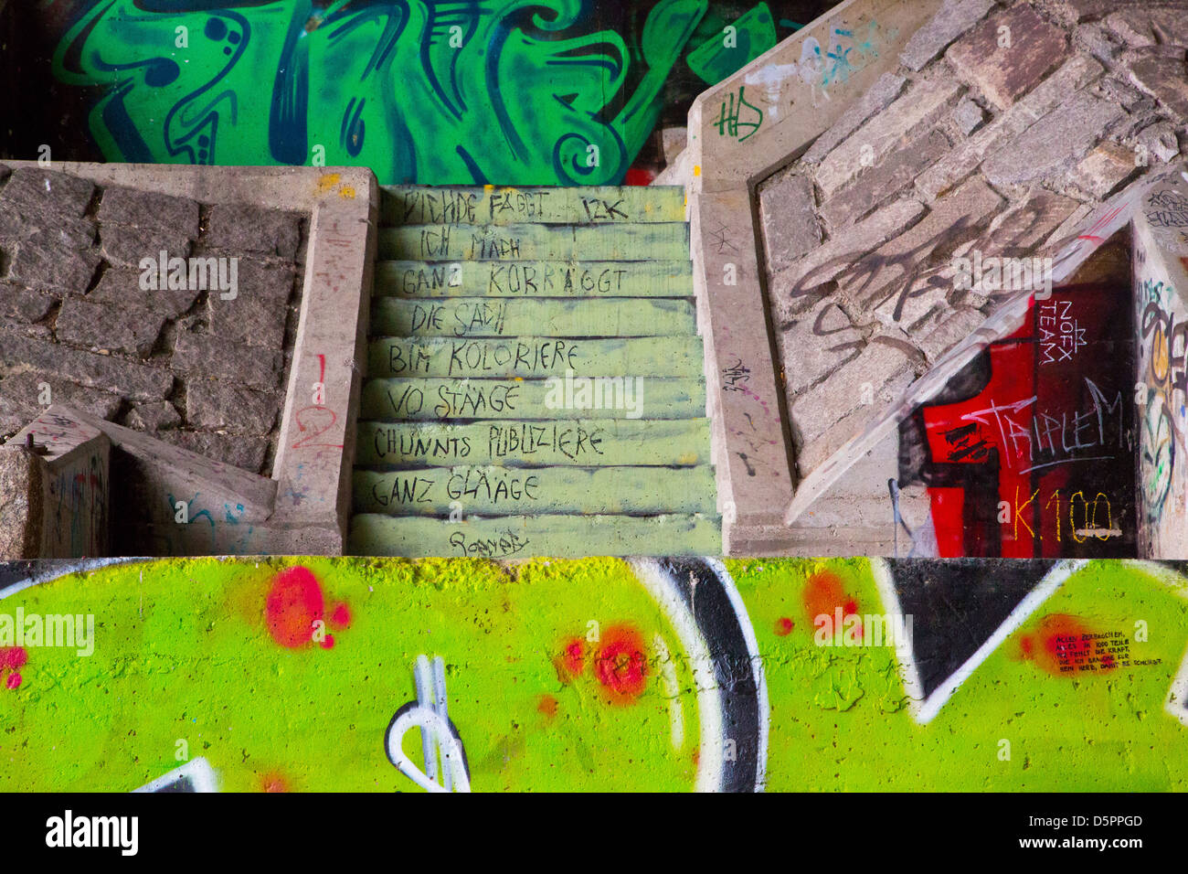 A photograph of some graffiti covered concrete steps, taken under a ...