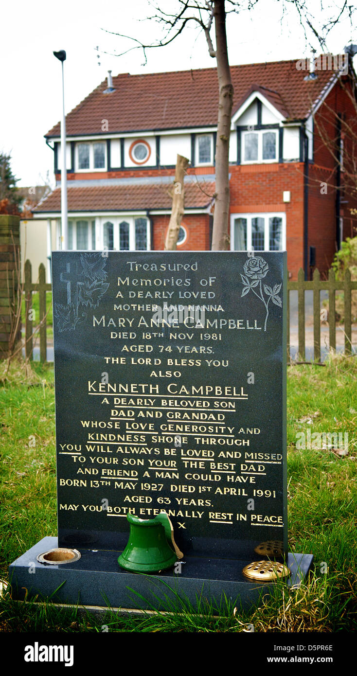 Grave headstone with detached house in background Stock Photo - Alamy