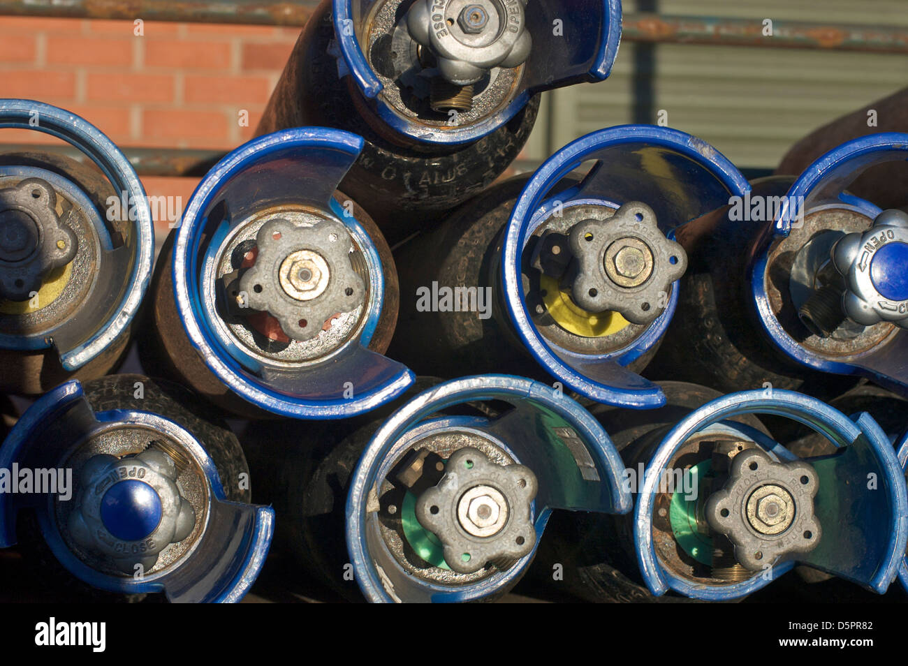 Gas cylinders stacked on rack in warehouse yard Stock Photo - Alamy