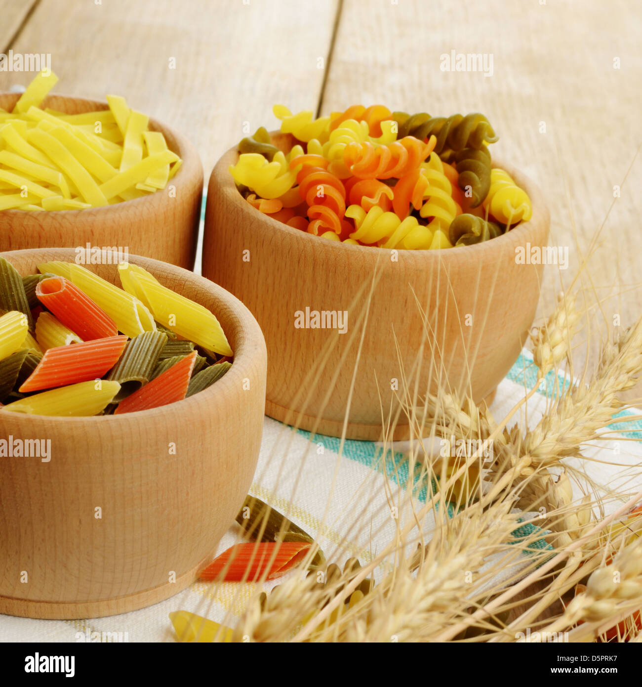 Raw tricolor pasta set on the wooden table Stock Photo - Alamy