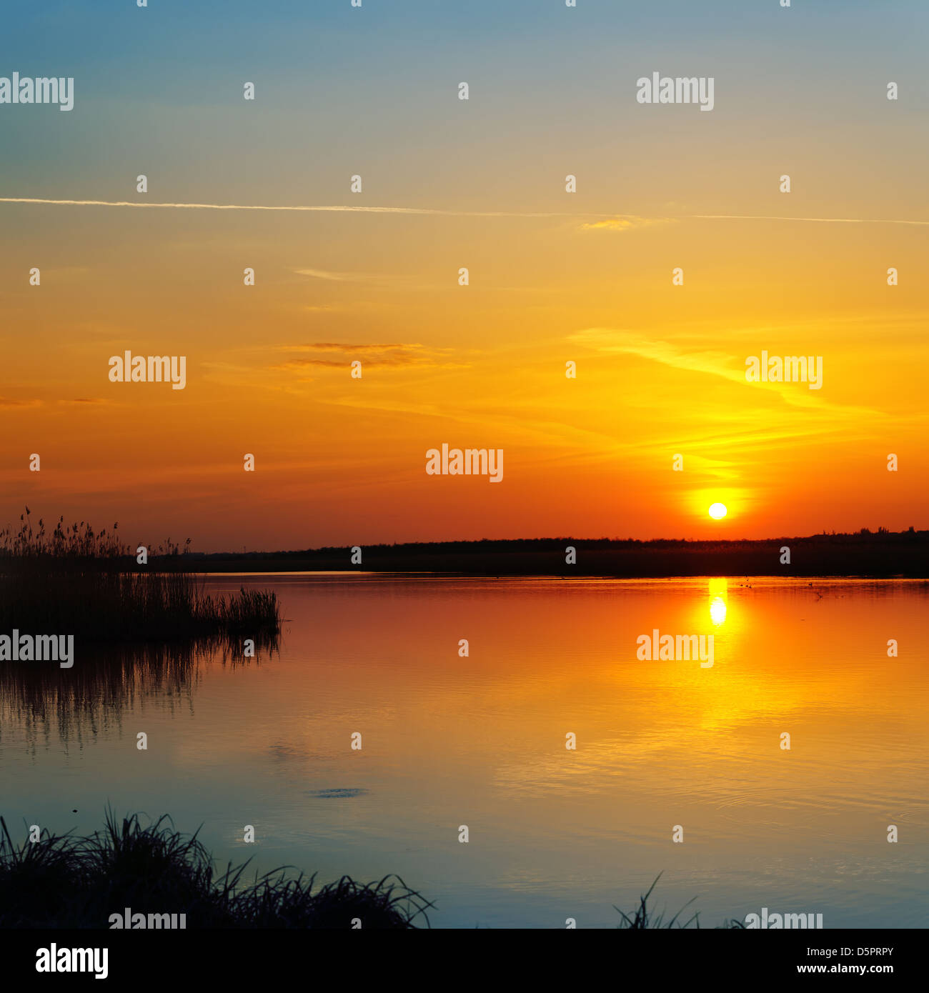 red sunset over river Stock Photo - Alamy