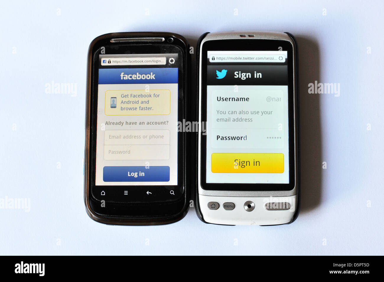 Two mobile phone screens showing web pages photographed in a studio ... Two mobile phone screens showing web pages photographed in a studio ...